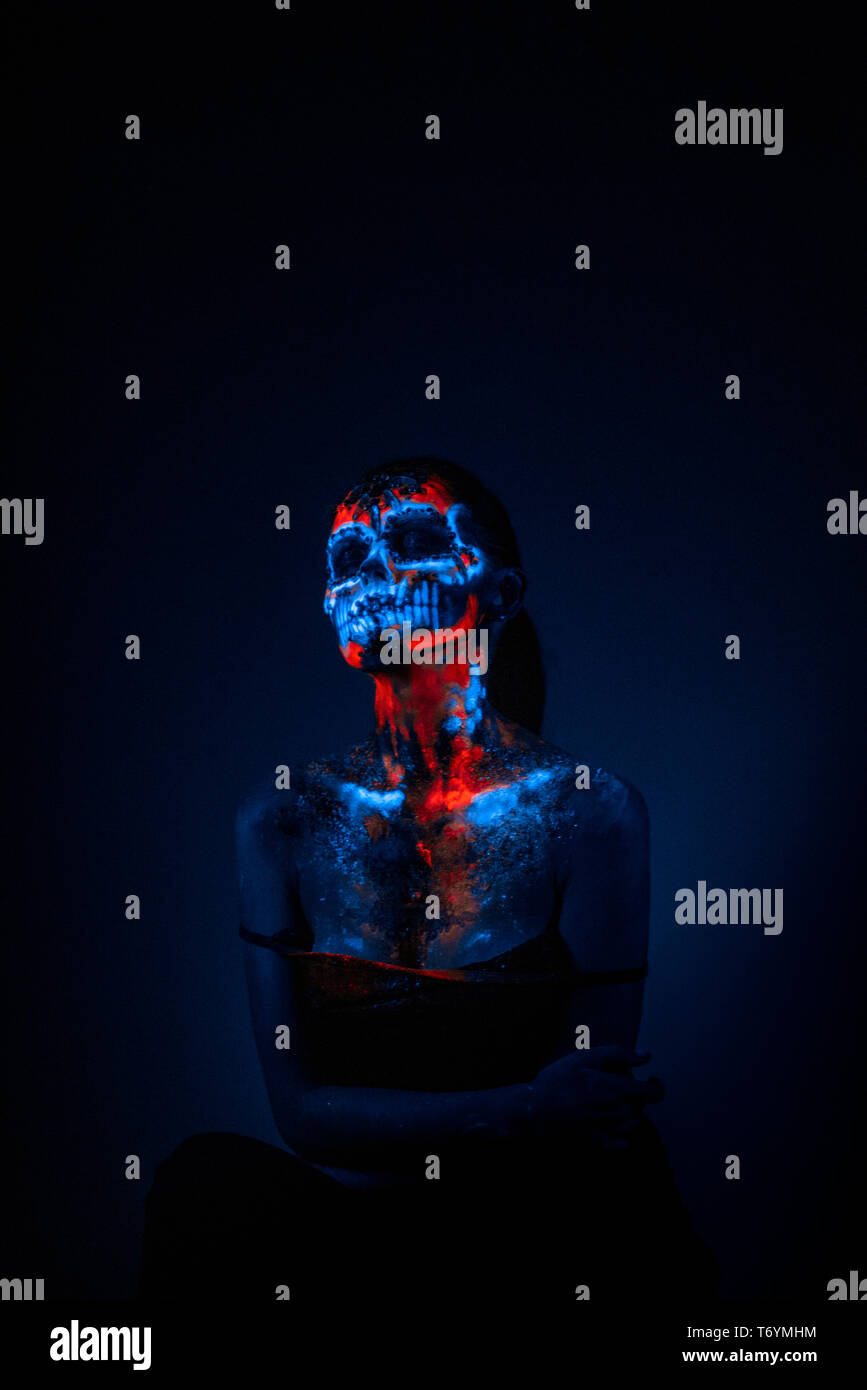 Girl's face painted UV skull Stock Photo - Alamy