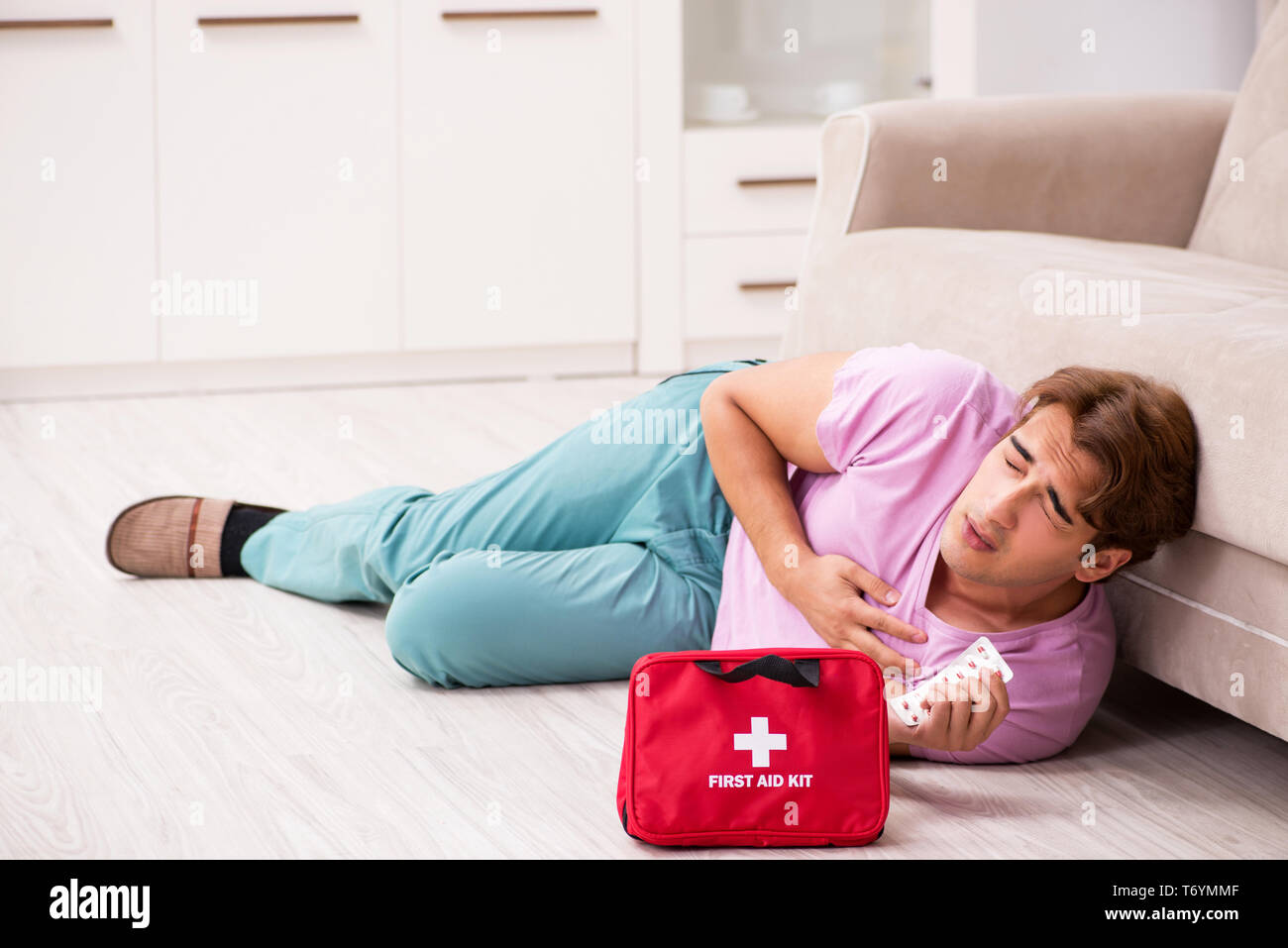 Sick man at home with first aid kit Stock Photo - Alamy