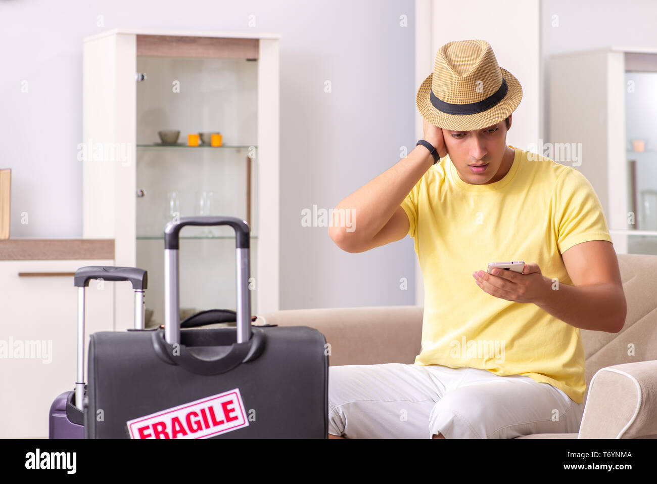 Man going on vacation with fragile suitcases Stock Photo - Alamy
