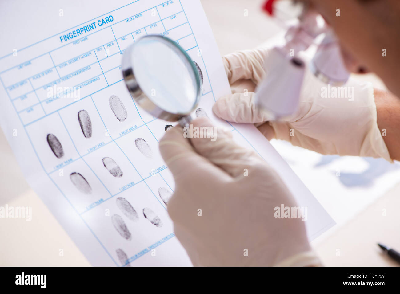Forensic expert studying fingerprints in the lab Stock Photo - Alamy