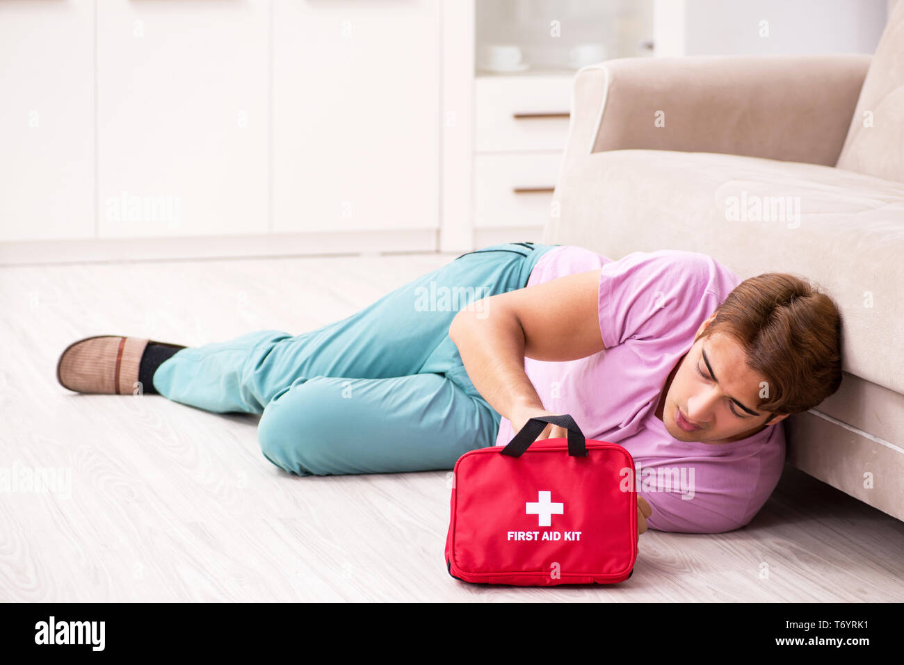The sick man at home with first aid kit Stock Photo - Alamy