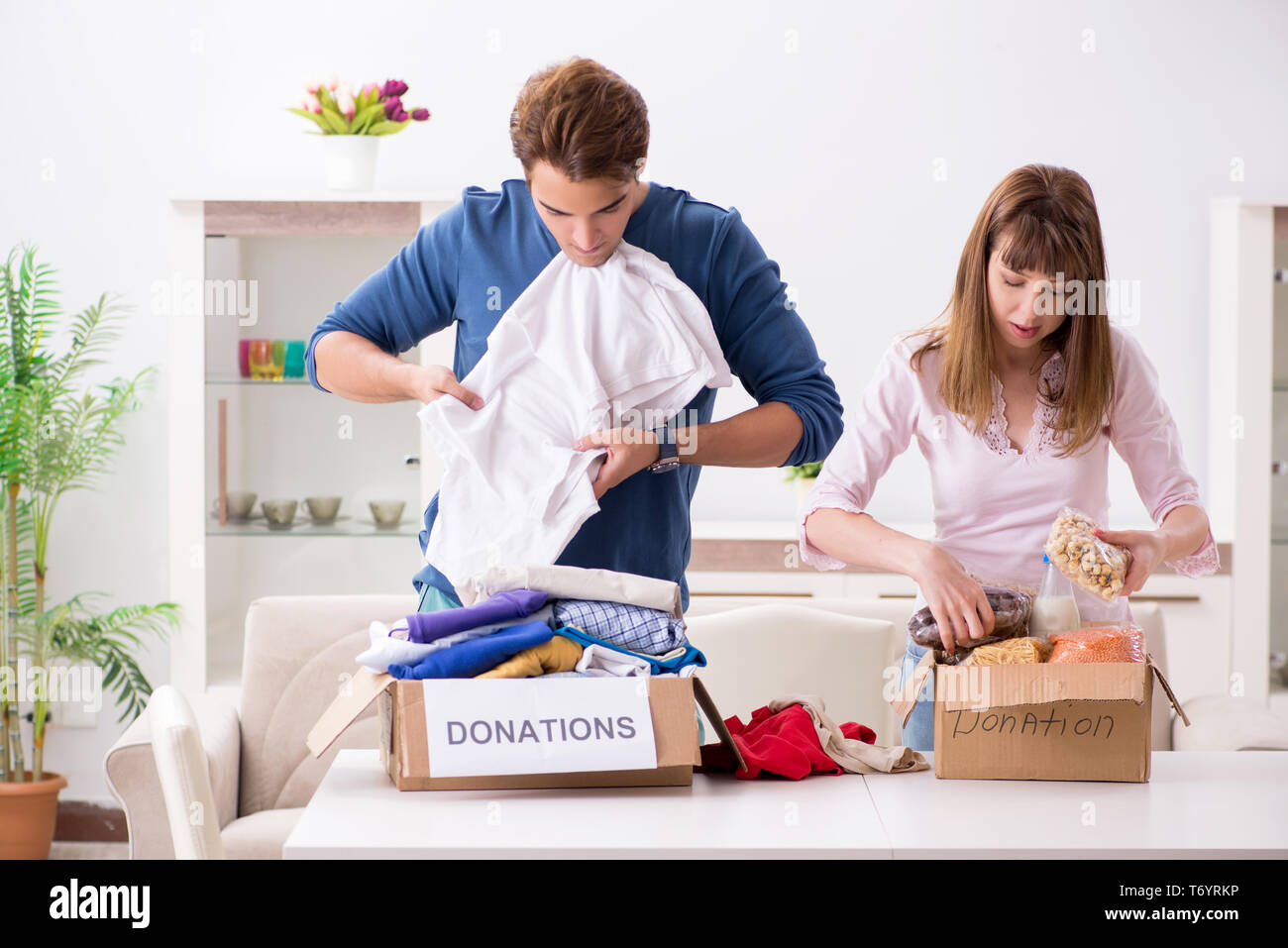 The concept of charity with donated clothing Stock Photo - Alamy