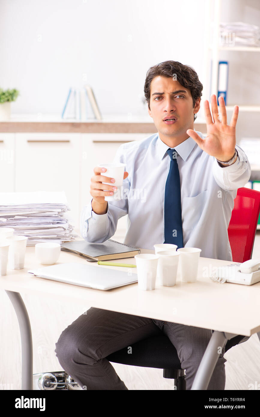 The young employee addicted to coffee Stock Photo - Alamy