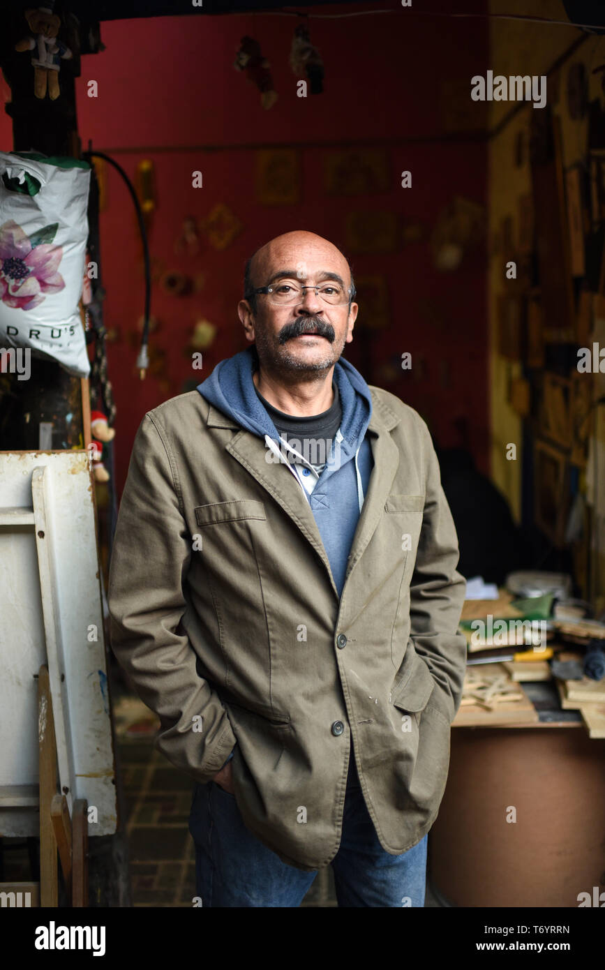 Craftsman Leonardo poses in his studio shop at La Candelaria, Bogota ...