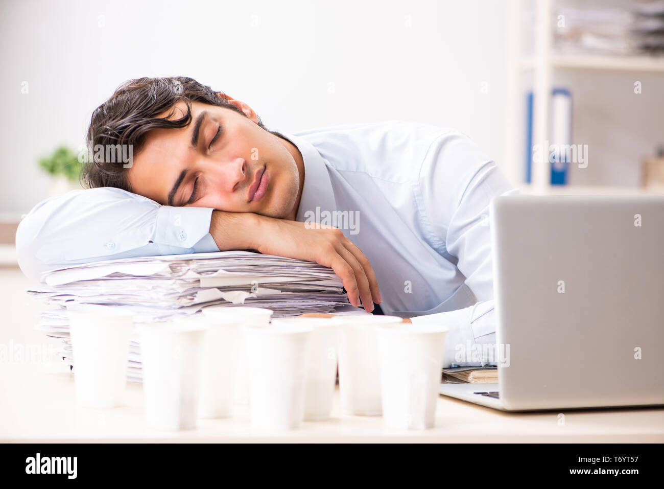 The young employee addicted to coffee Stock Photo - Alamy