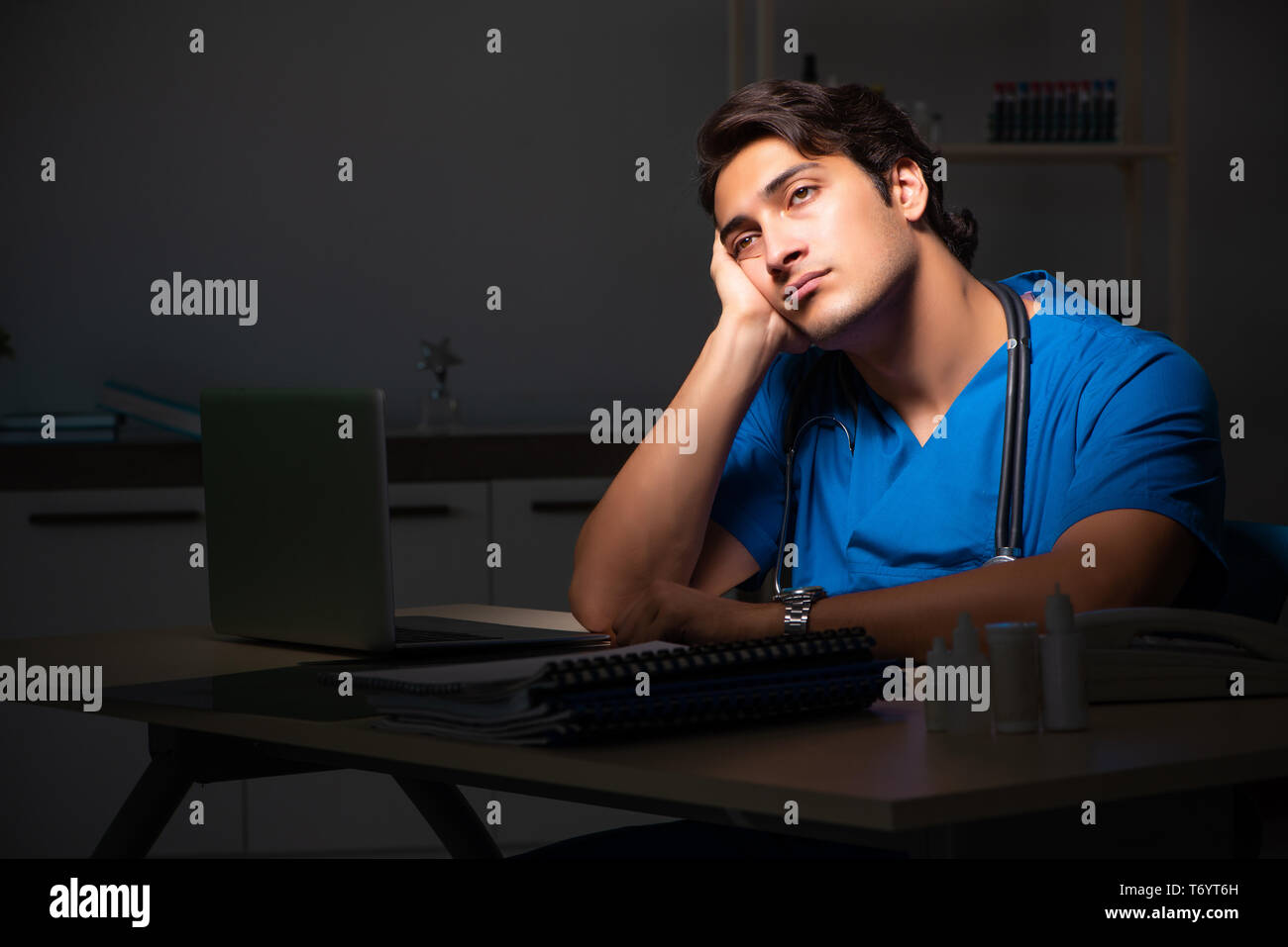 The young handsome doctor working night shift in hospital Stock Photo ...
