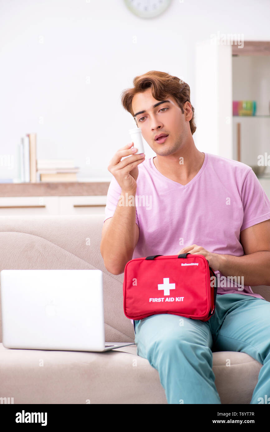 The sick man at home with first aid kit Stock Photo - Alamy