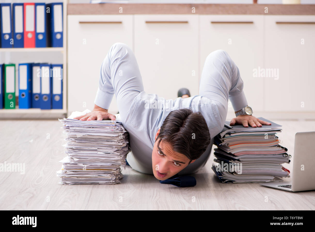 The extremely busy employee working in the office Stock Photo - Alamy