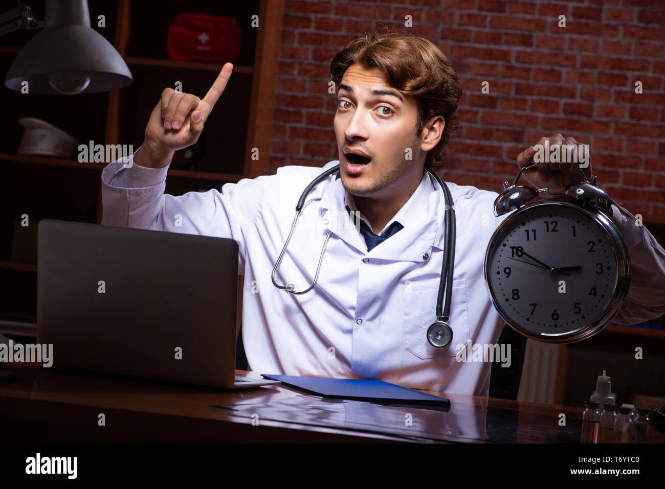 The young handsome doctor working night time at the hospital Stock ...