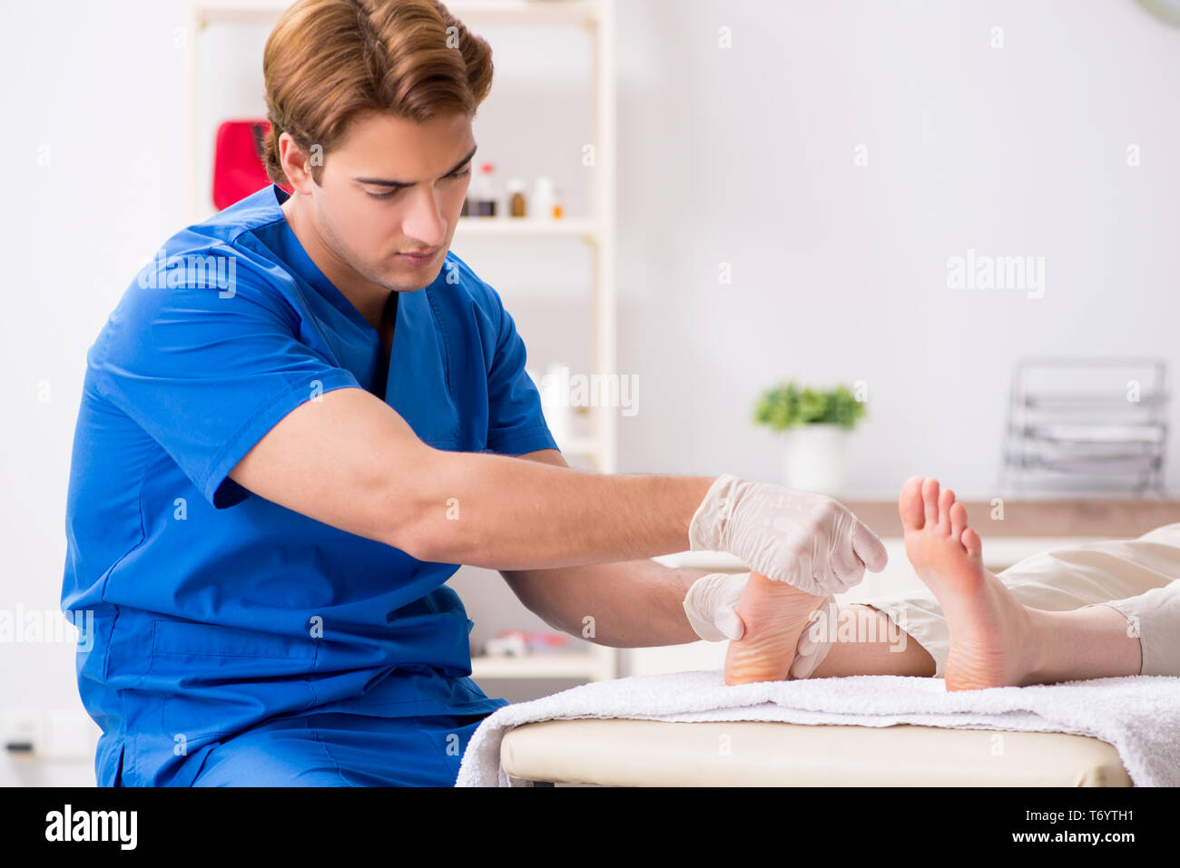 The podiatrist treating feet during procedure Stock Photo - Alamy