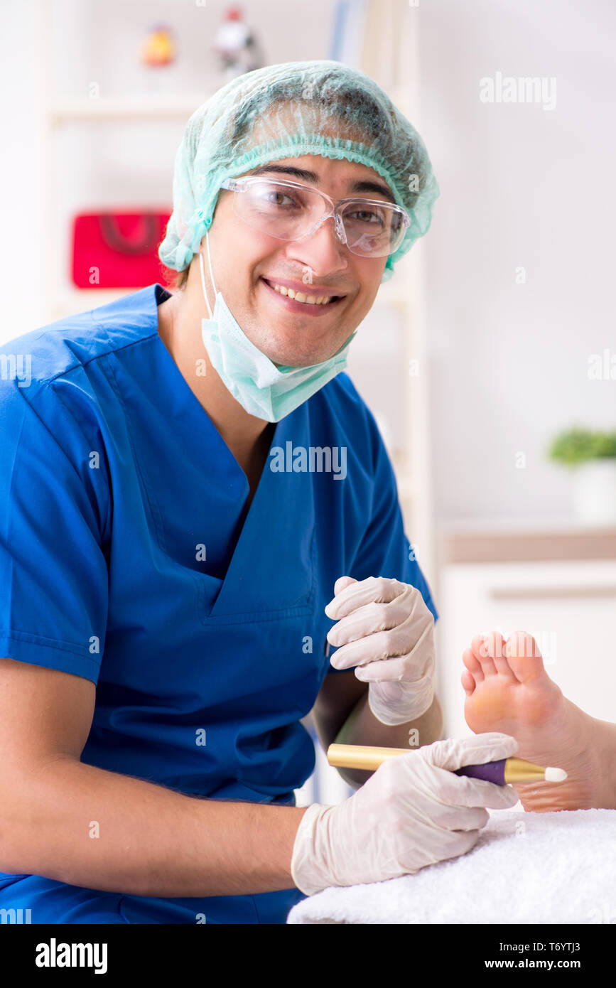 The podiatrist treating feet during procedure Stock Photo - Alamy