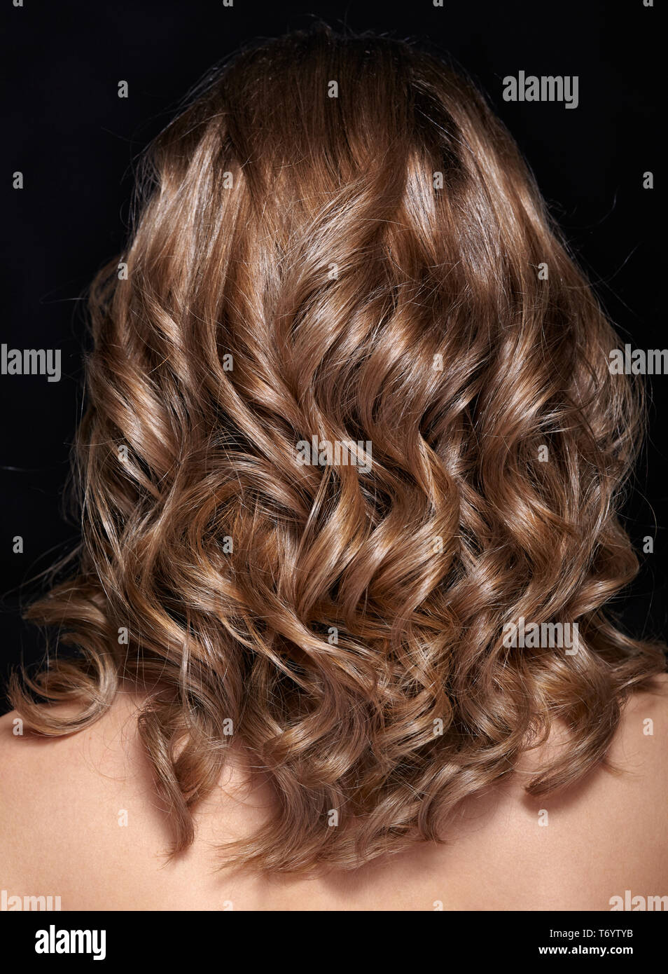 Woman from backside with curly hair Stock Photo - Alamy