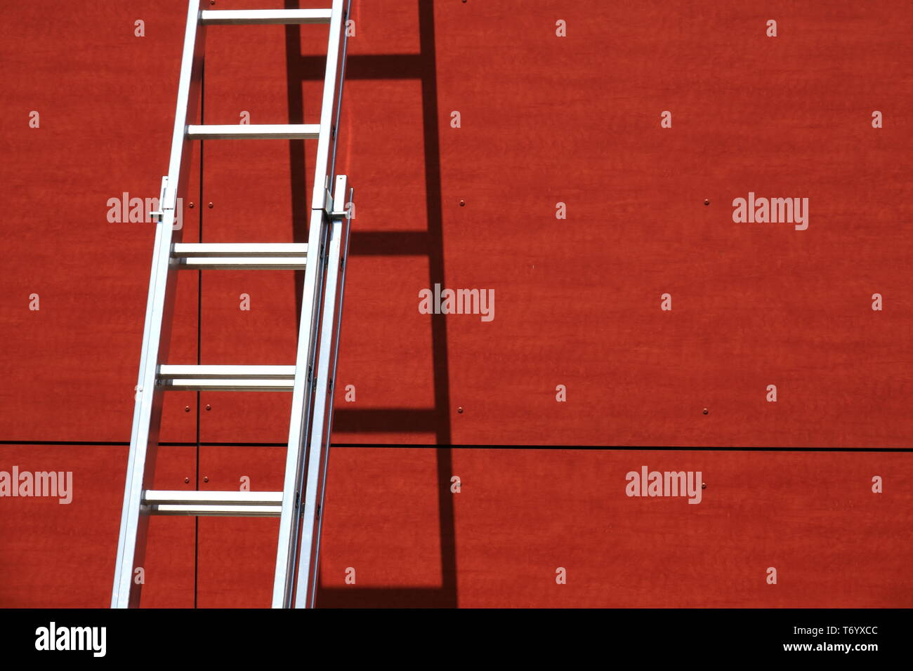 Aluminum ladder on red house wall hi-res stock photography and images ...