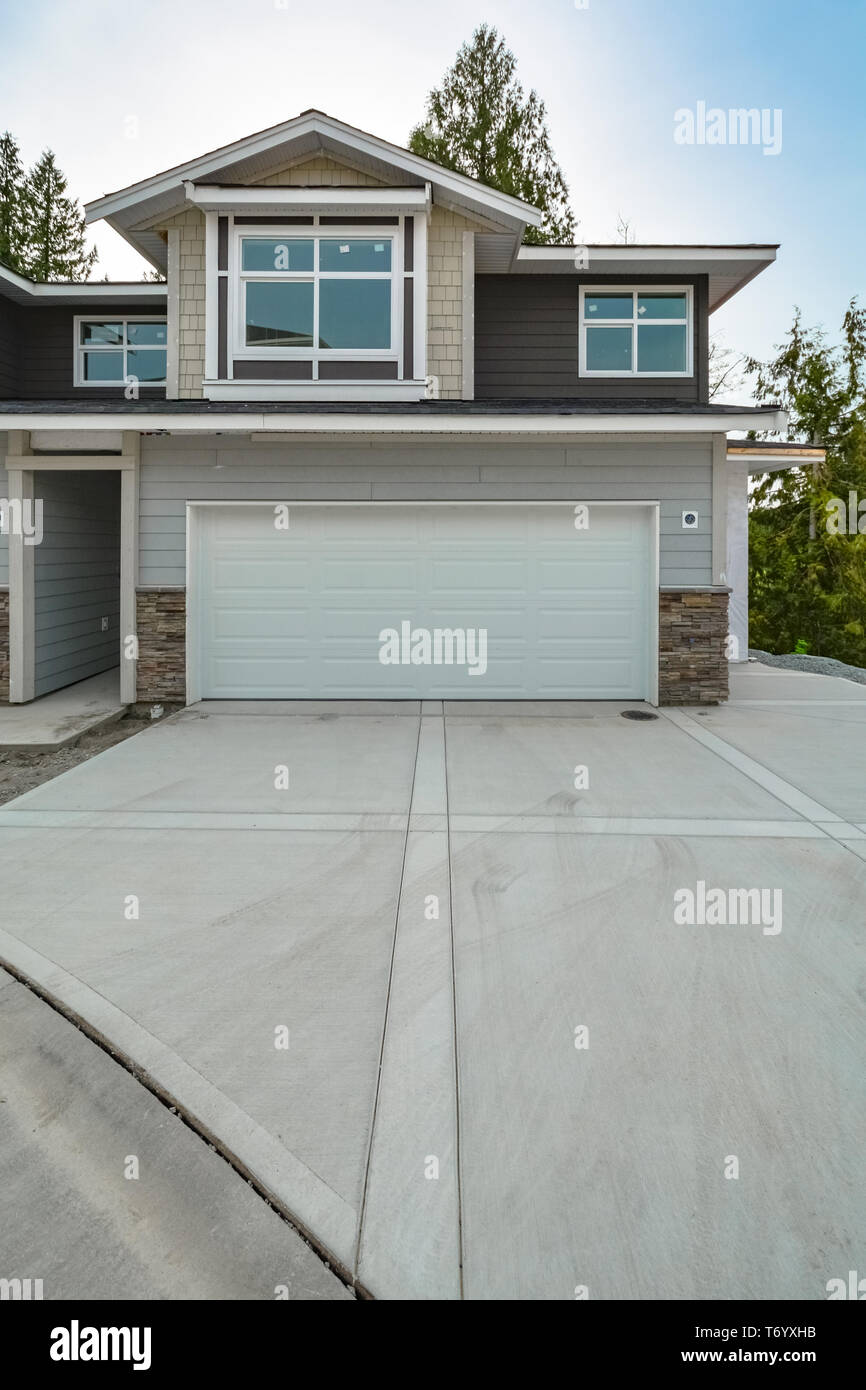Concrete driveway of brand new residential triplex house Stock Photo ...