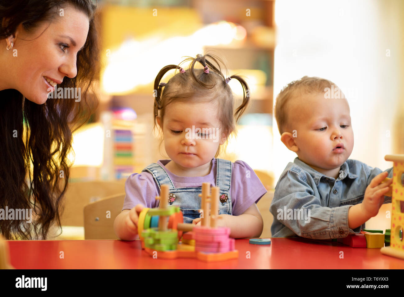 Teacher teaching children play toy in classroom. Kindergarten pre ...