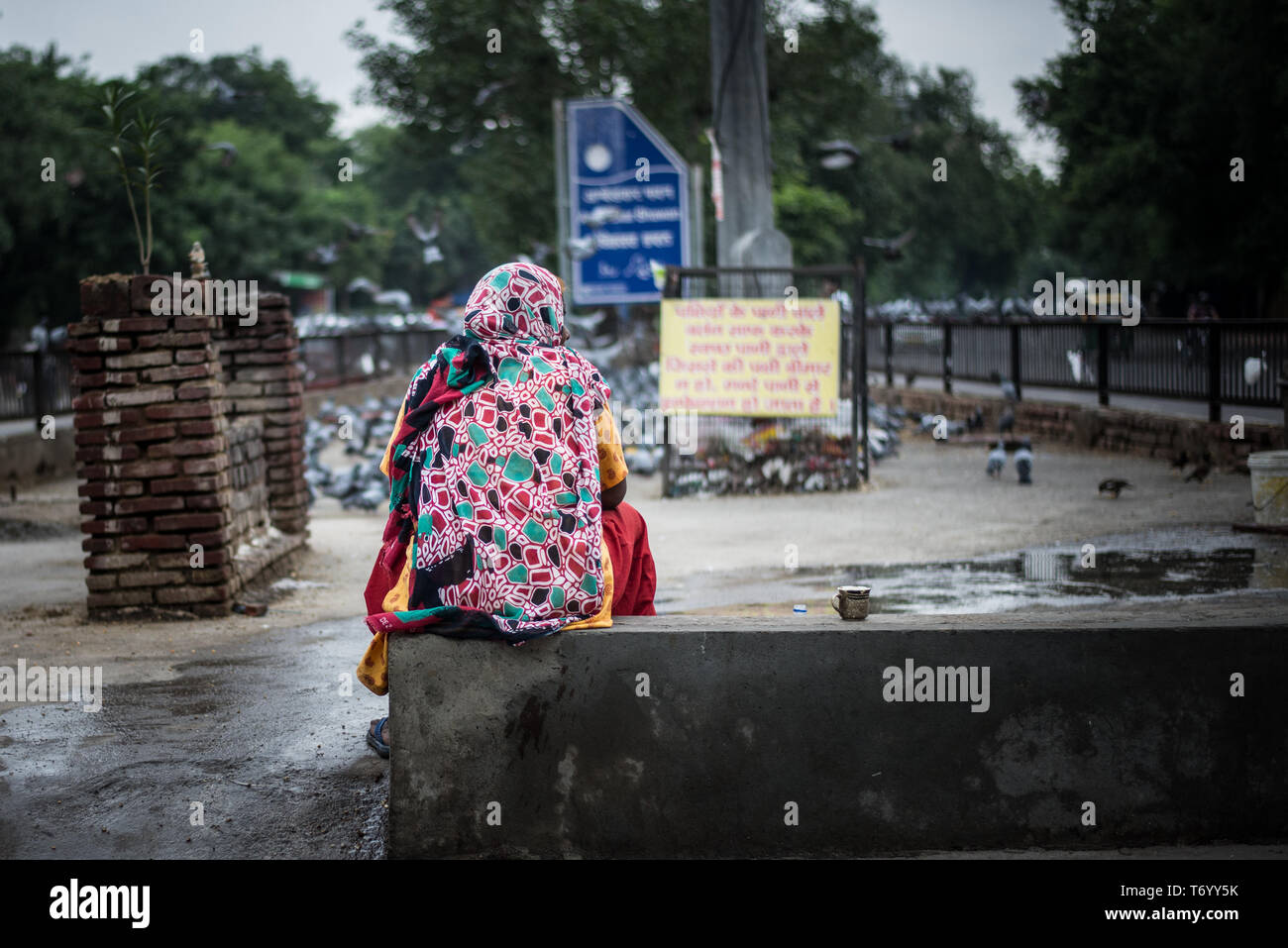 Woman sitting on step Stock Photo - Alamy