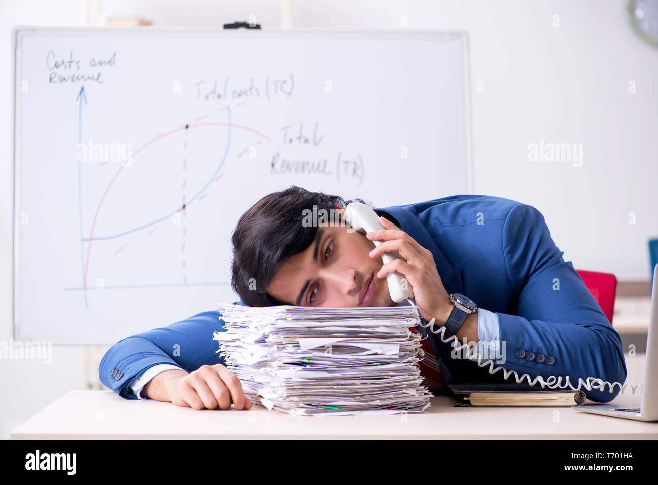 Busy businessman explaining business charts Stock Photo - Alamy
