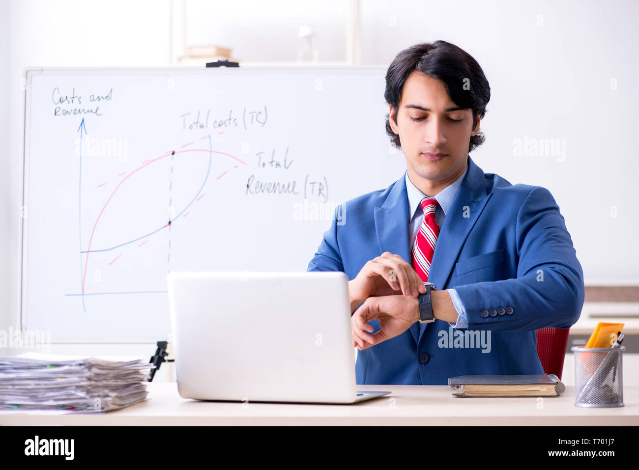 Busy businessman explaining business charts Stock Photo - Alamy
