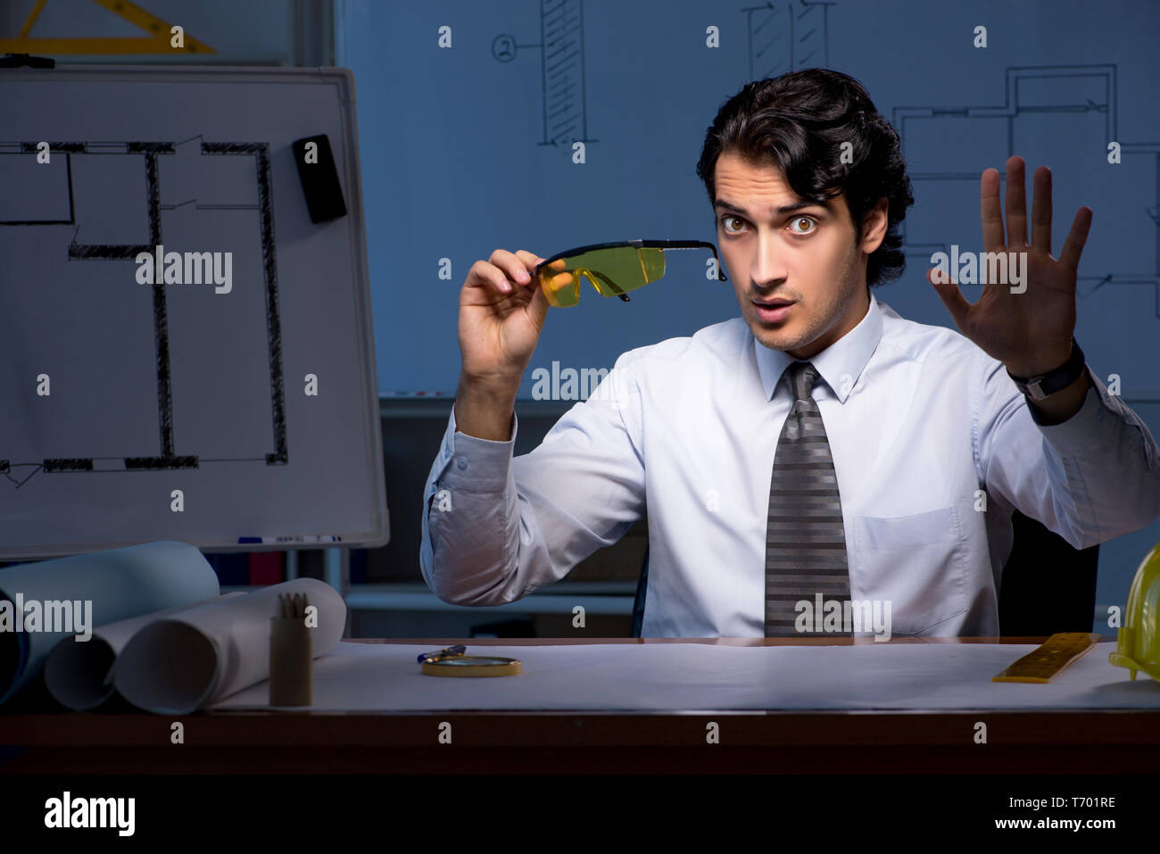 Young construction architect working on project at night Stock Photo ...