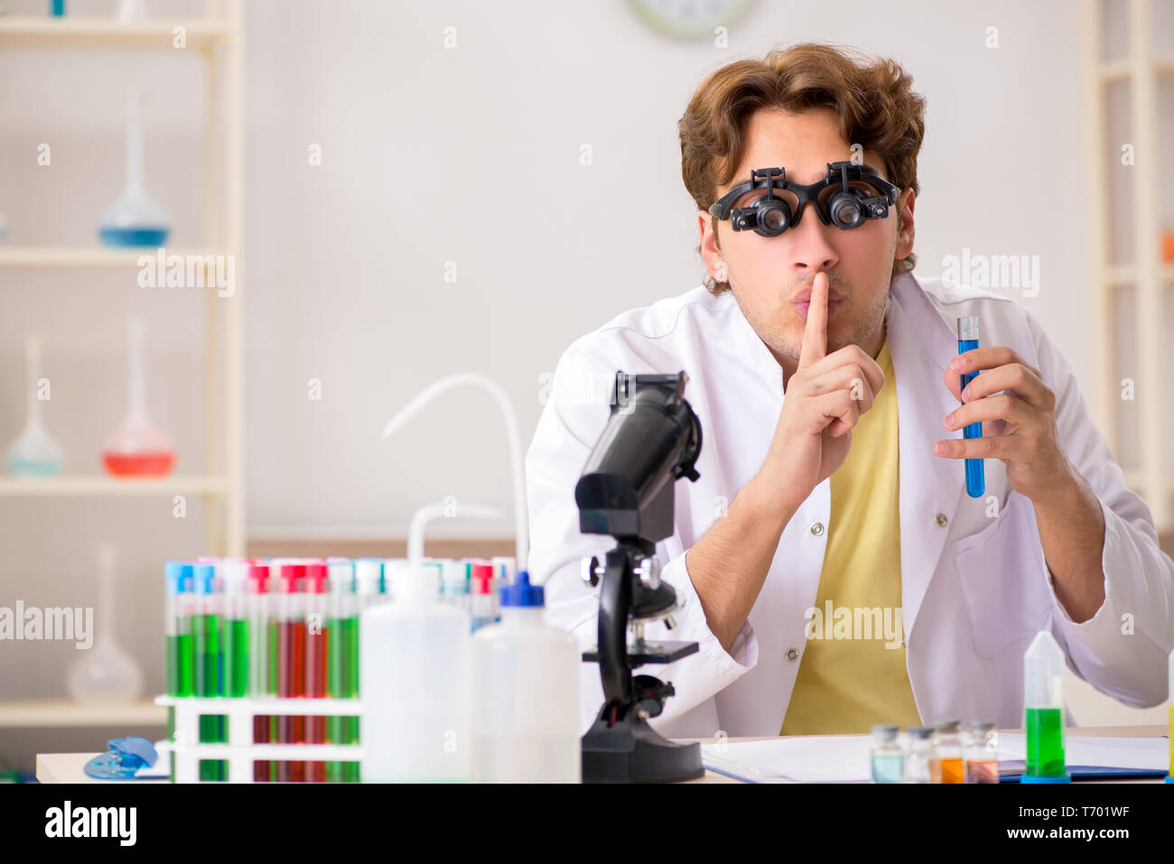 Funny crazy chemist doing experiments and tests Stock Photo - Alamy