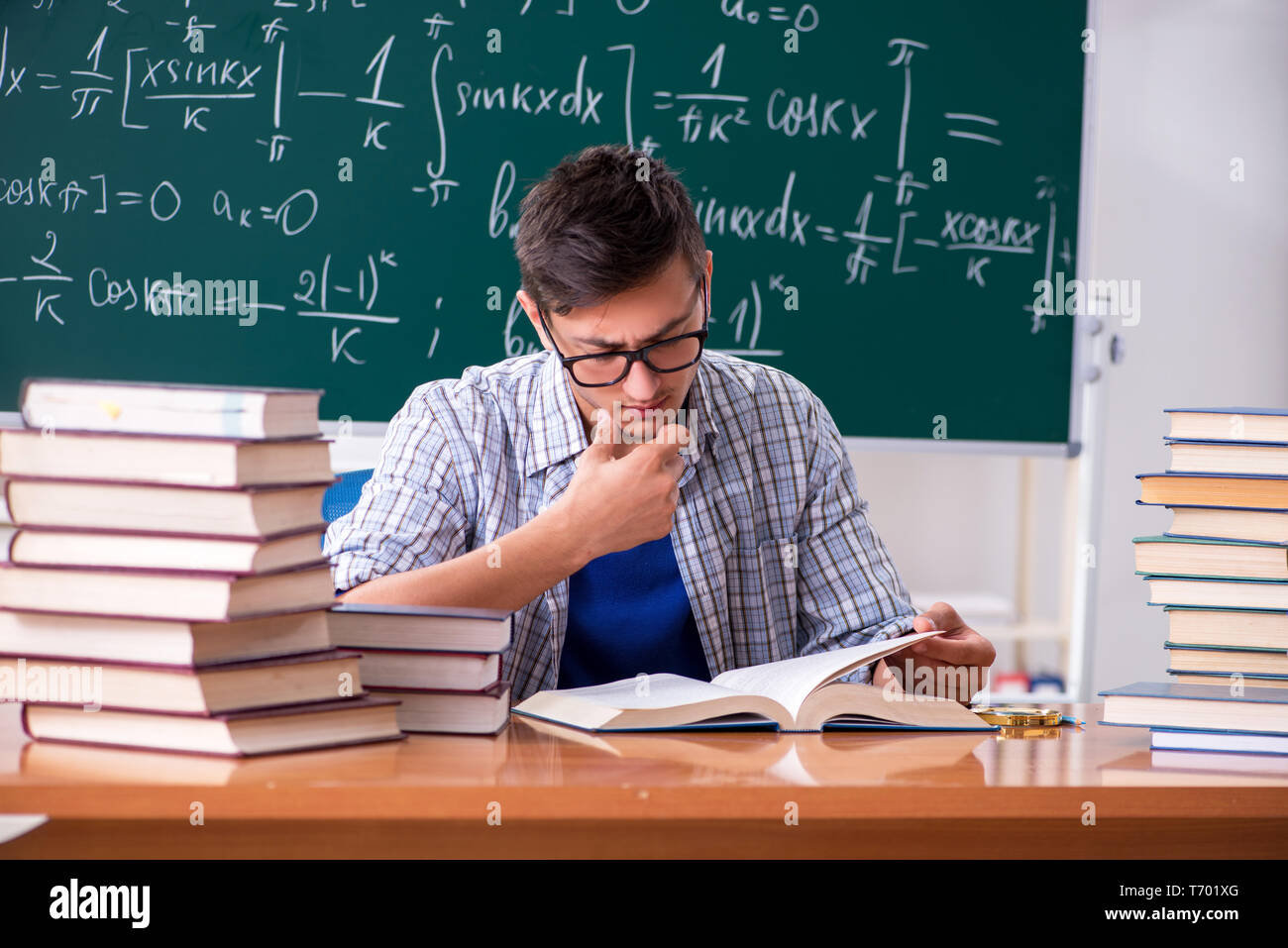 Young male student studying math at school Stock Photo - Alamy