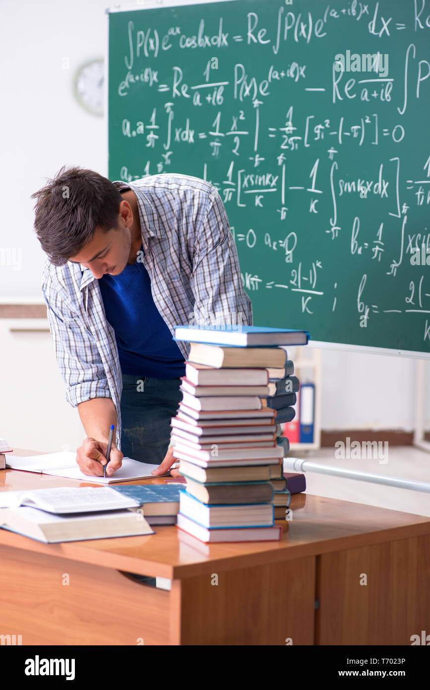 Young male student studying math at school Stock Photo - Alamy