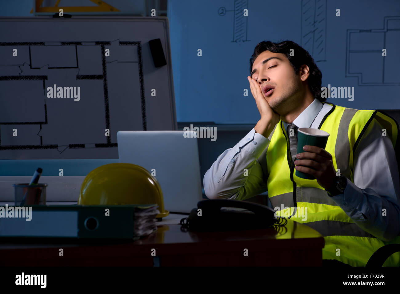 Young construction architect working on project at night Stock Photo ...
