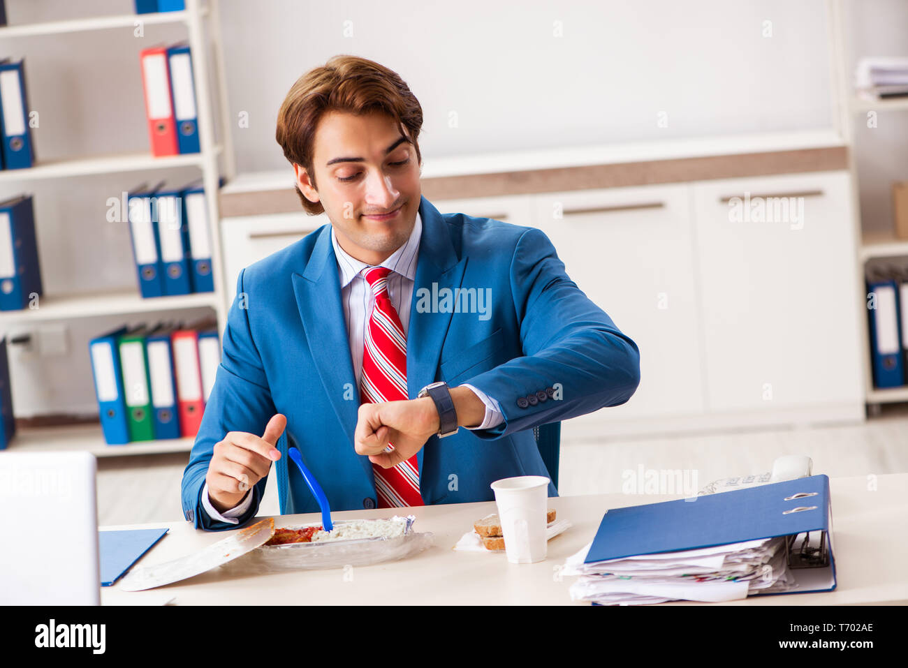 Man having meal at work during break Stock Photo - Alamy