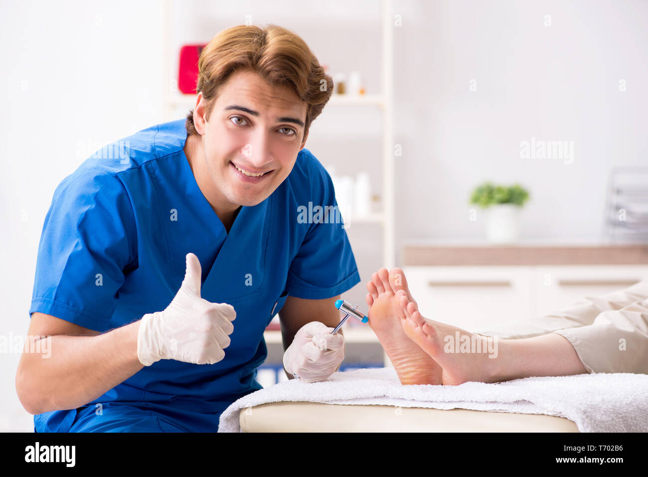 Podiatrist treating feet during procedure Stock Photo - Alamy