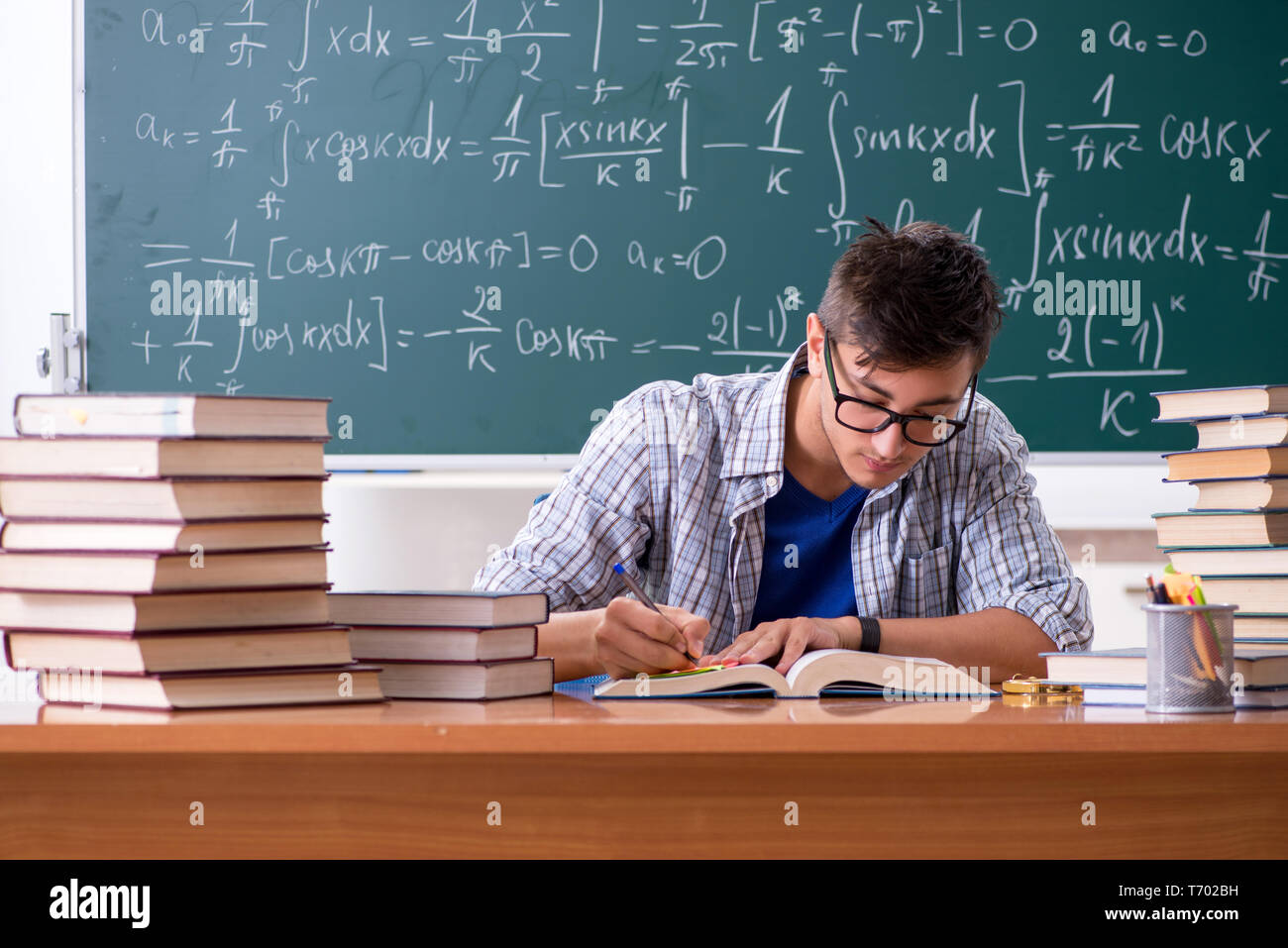 Young male student studying math at school Stock Photo - Alamy