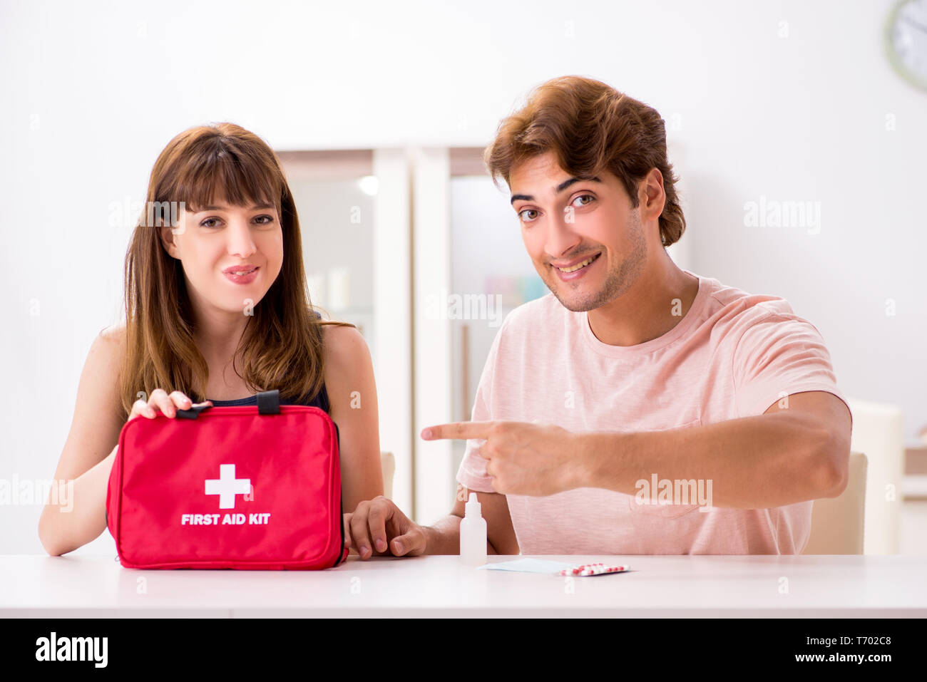 Young family getting treatment with first aid kit Stock Photo - Alamy