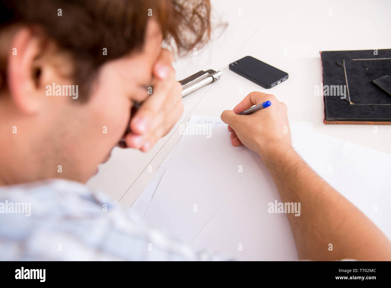 Sad man writing letter hi-res stock photography and images - Alamy