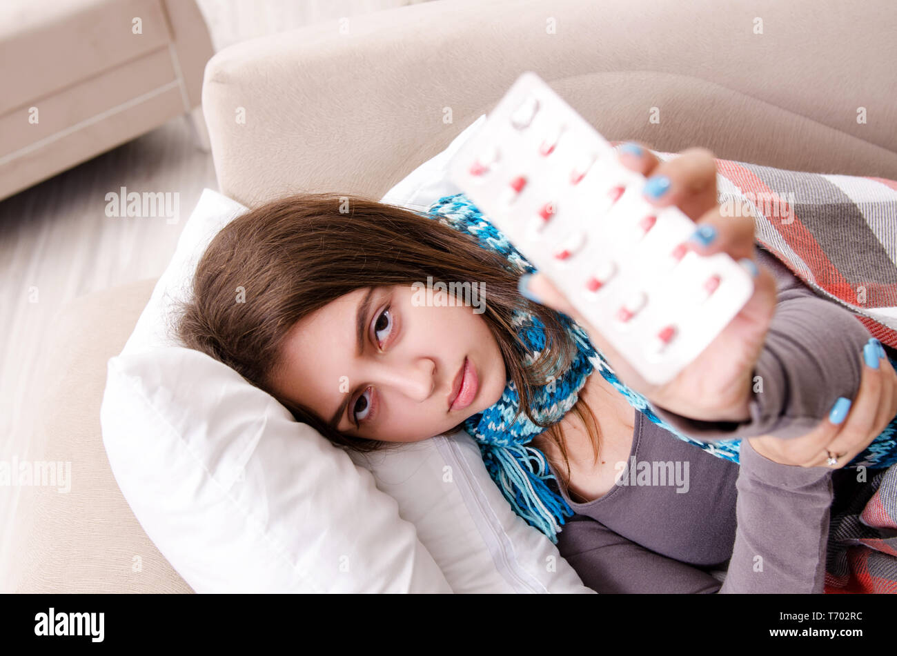 Sick young woman suffering at home Stock Photo - Alamy