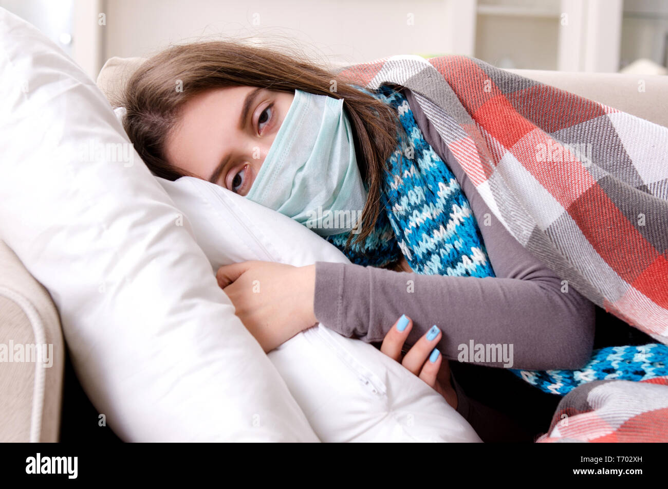 Sick young woman suffering at home Stock Photo - Alamy