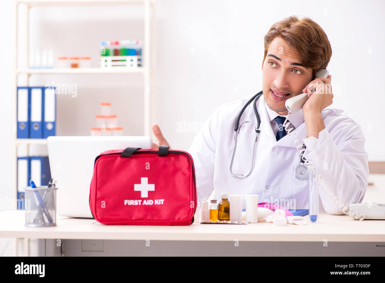 Young doctor with first aid kit in hospital Stock Photo - Alamy