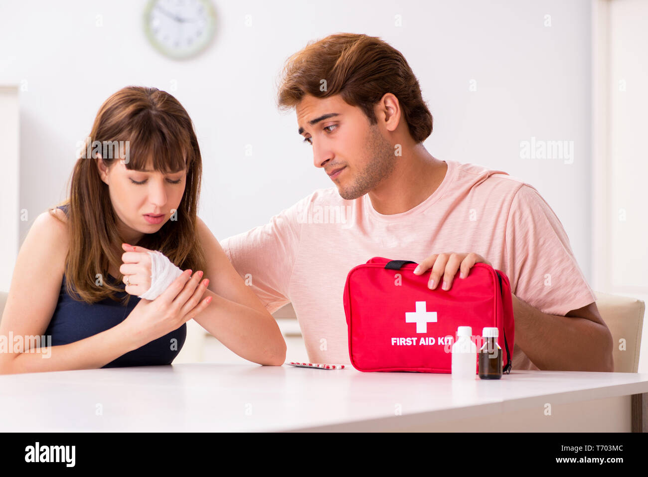 Young family getting treatment with first aid kit Stock Photo - Alamy