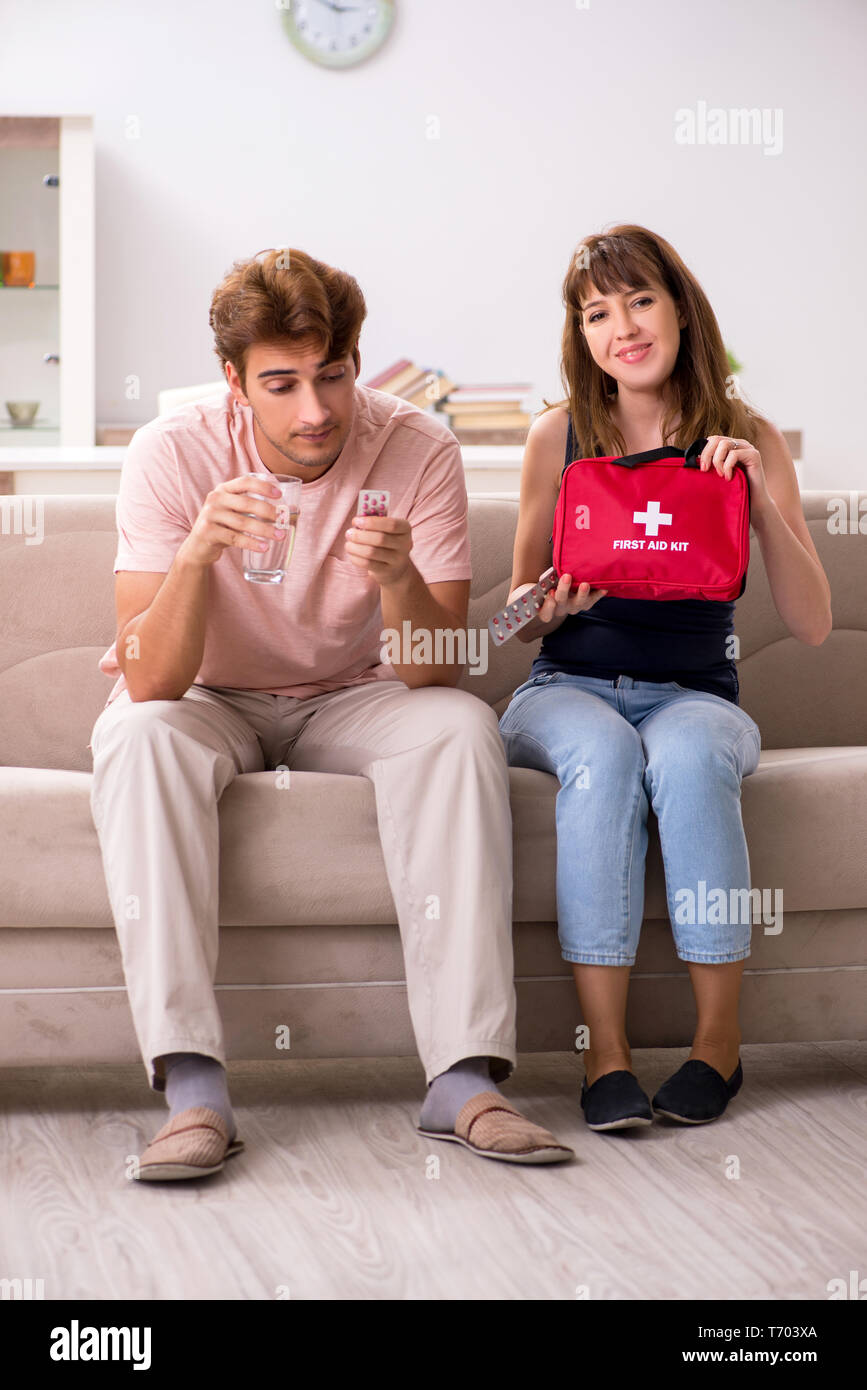 Young family getting treatment with first aid kit Stock Photo - Alamy
