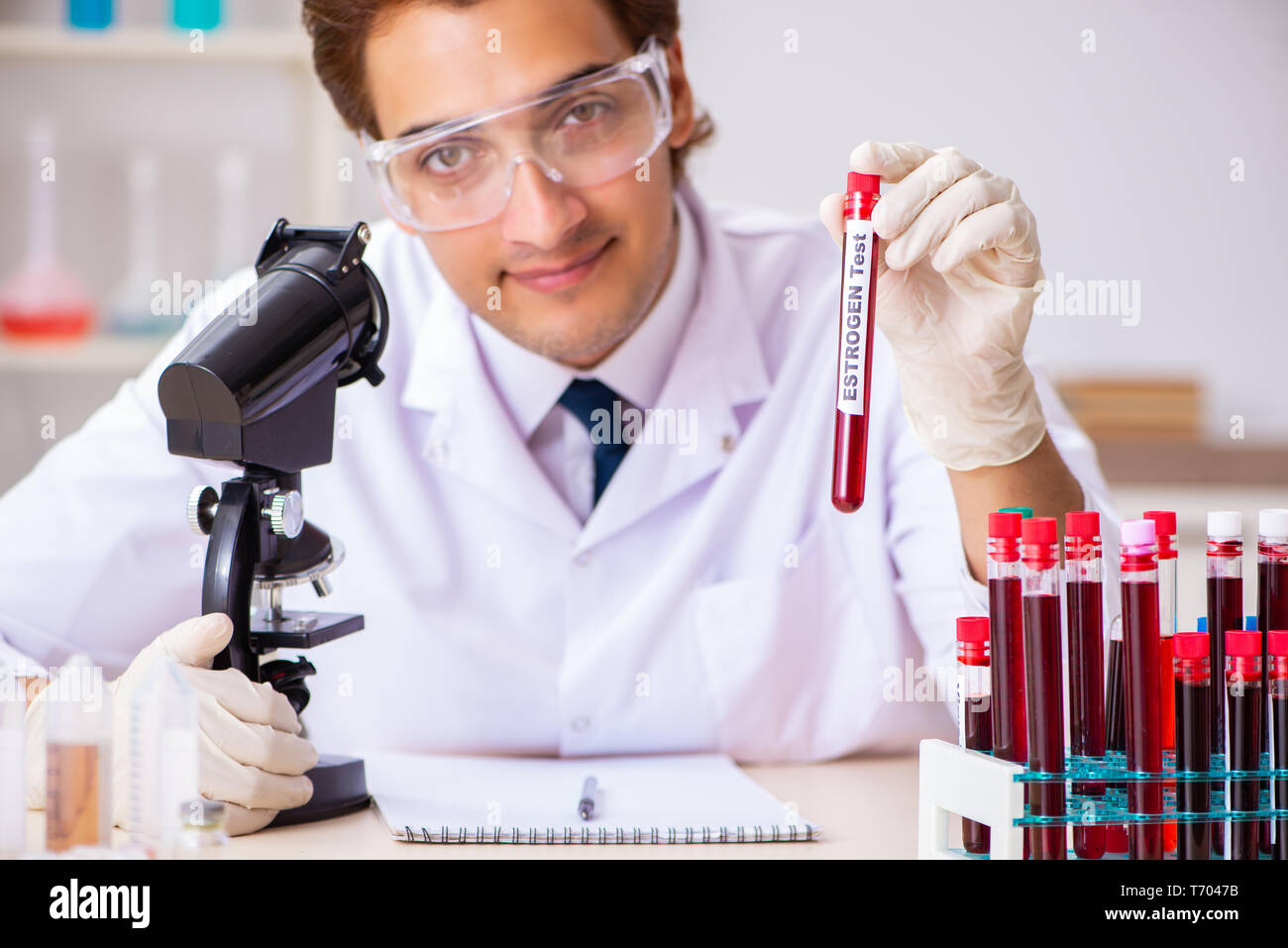 Female chemist checking blood hi-res stock photography and images - Alamy