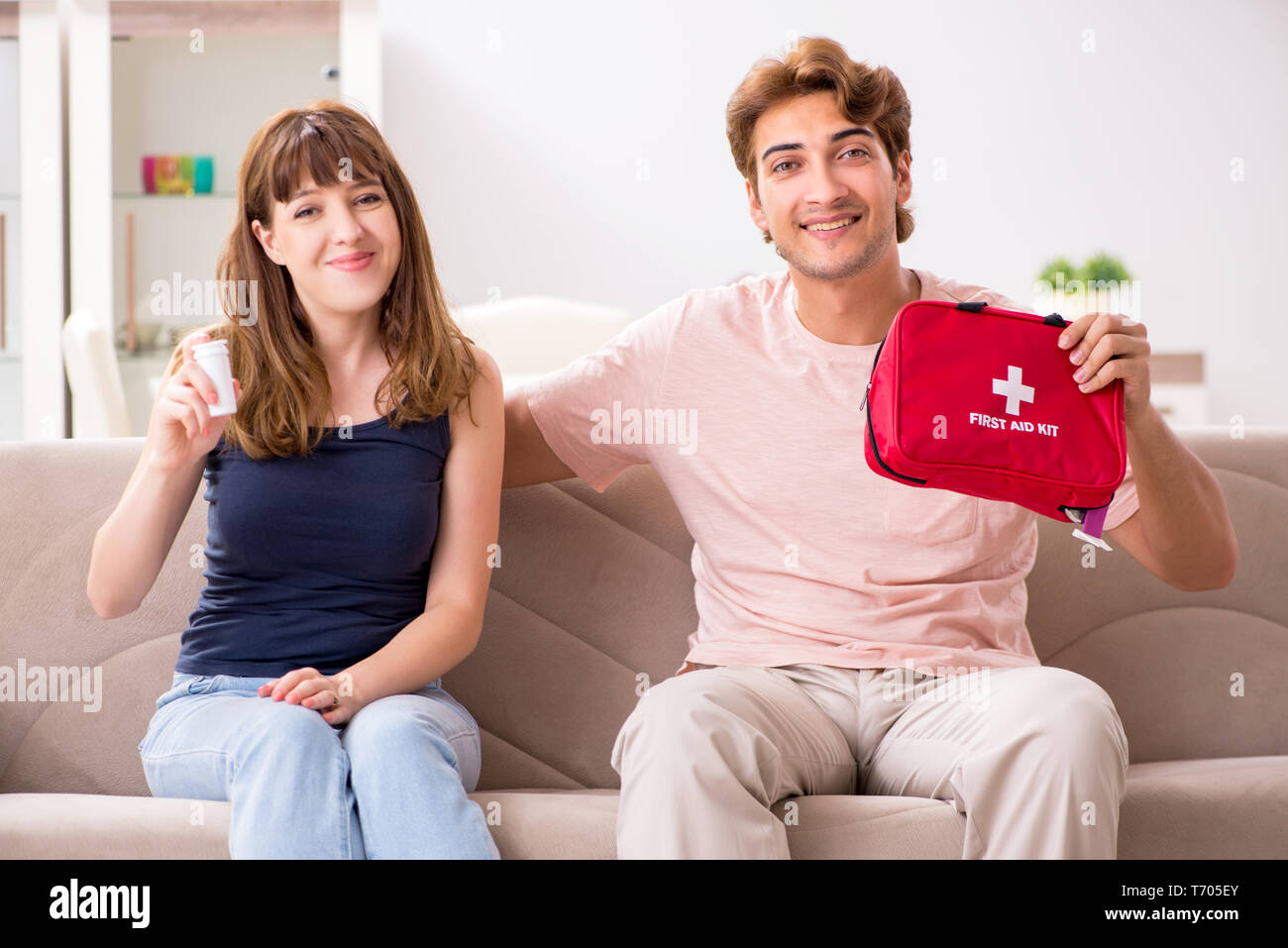 Young family getting treatment with first aid kit Stock Photo - Alamy