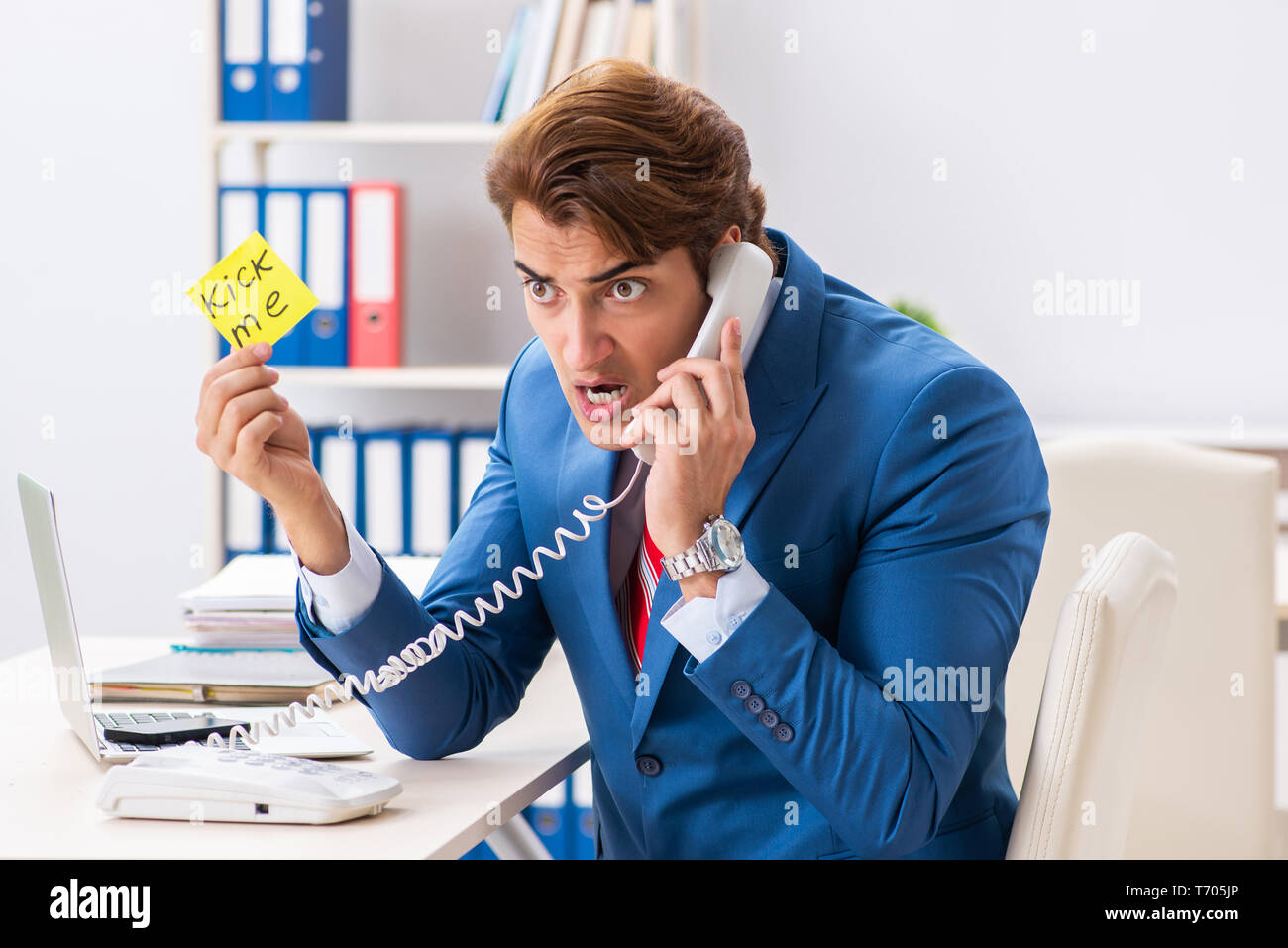 Office prank with kick me message on sticky note Stock Photo - Alamy