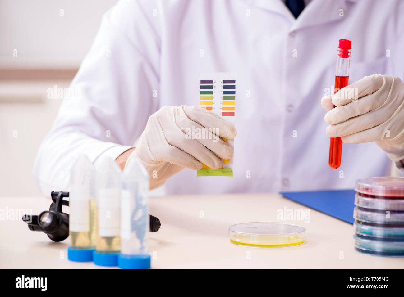 Chemist in the lab checking with ph strips Stock Photo - Alamy
