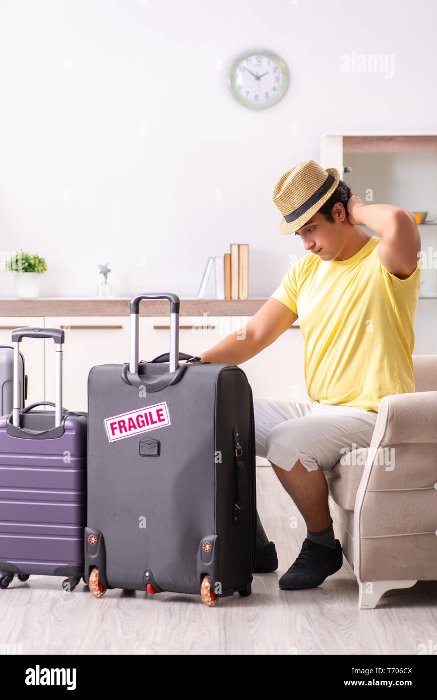 Man going on vacation with fragile suitcases Stock Photo - Alamy