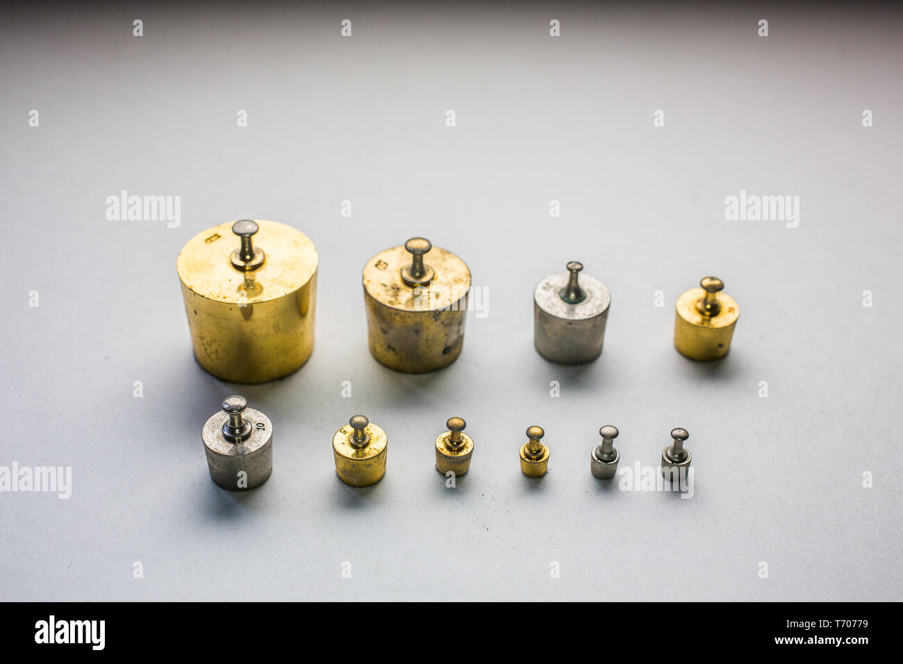 Weight set made of brass Stock Photo - Alamy
