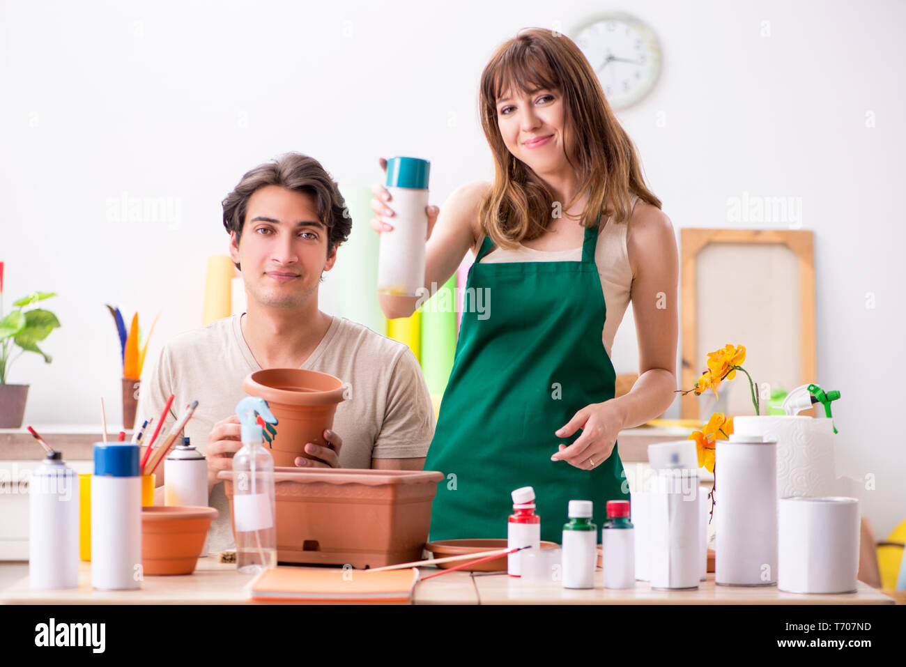 The couple decorating pots in workshop during class Stock Photo - Alamy