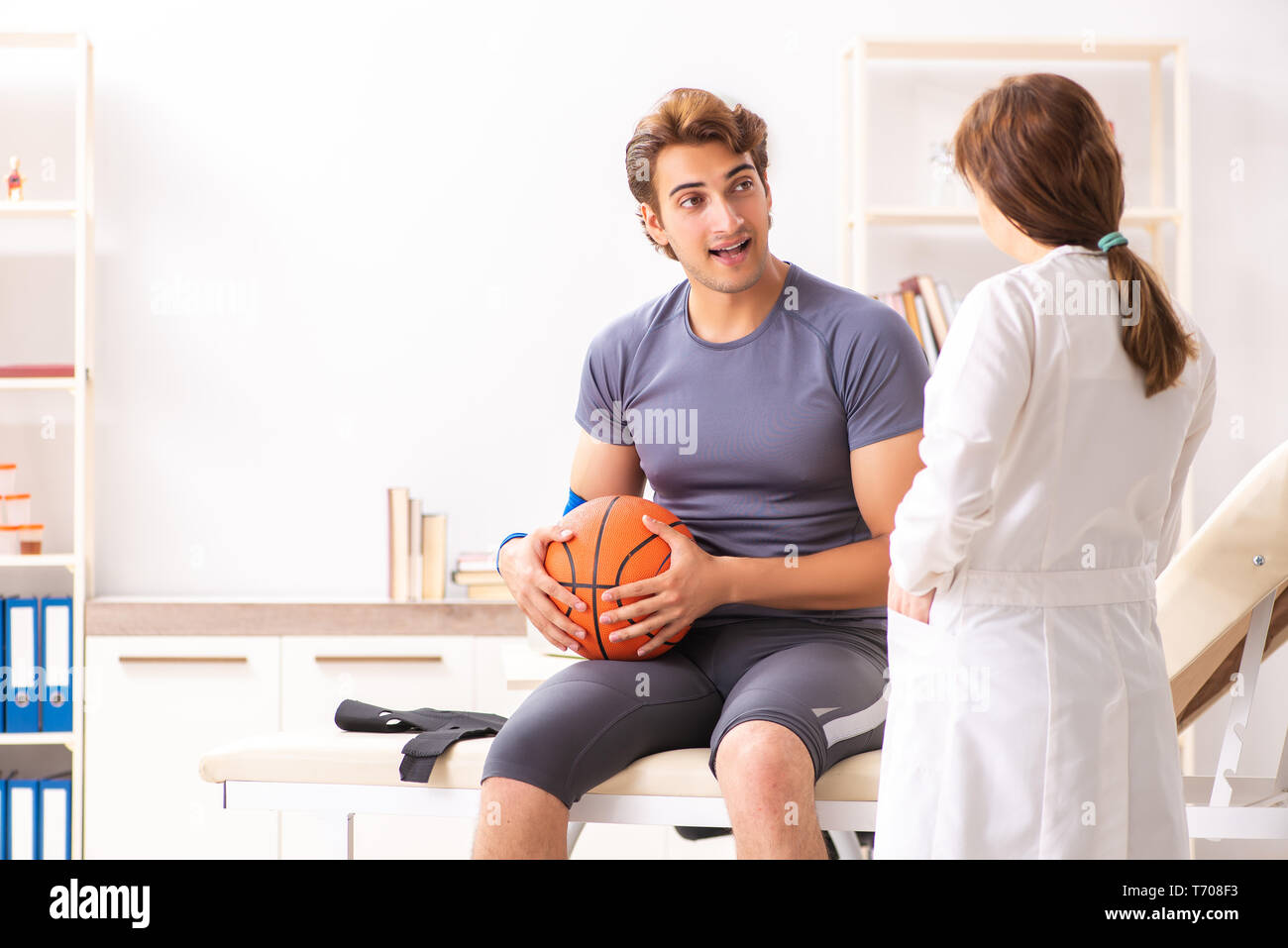 The handsome basketball player visiting female doctor traumatologist ...