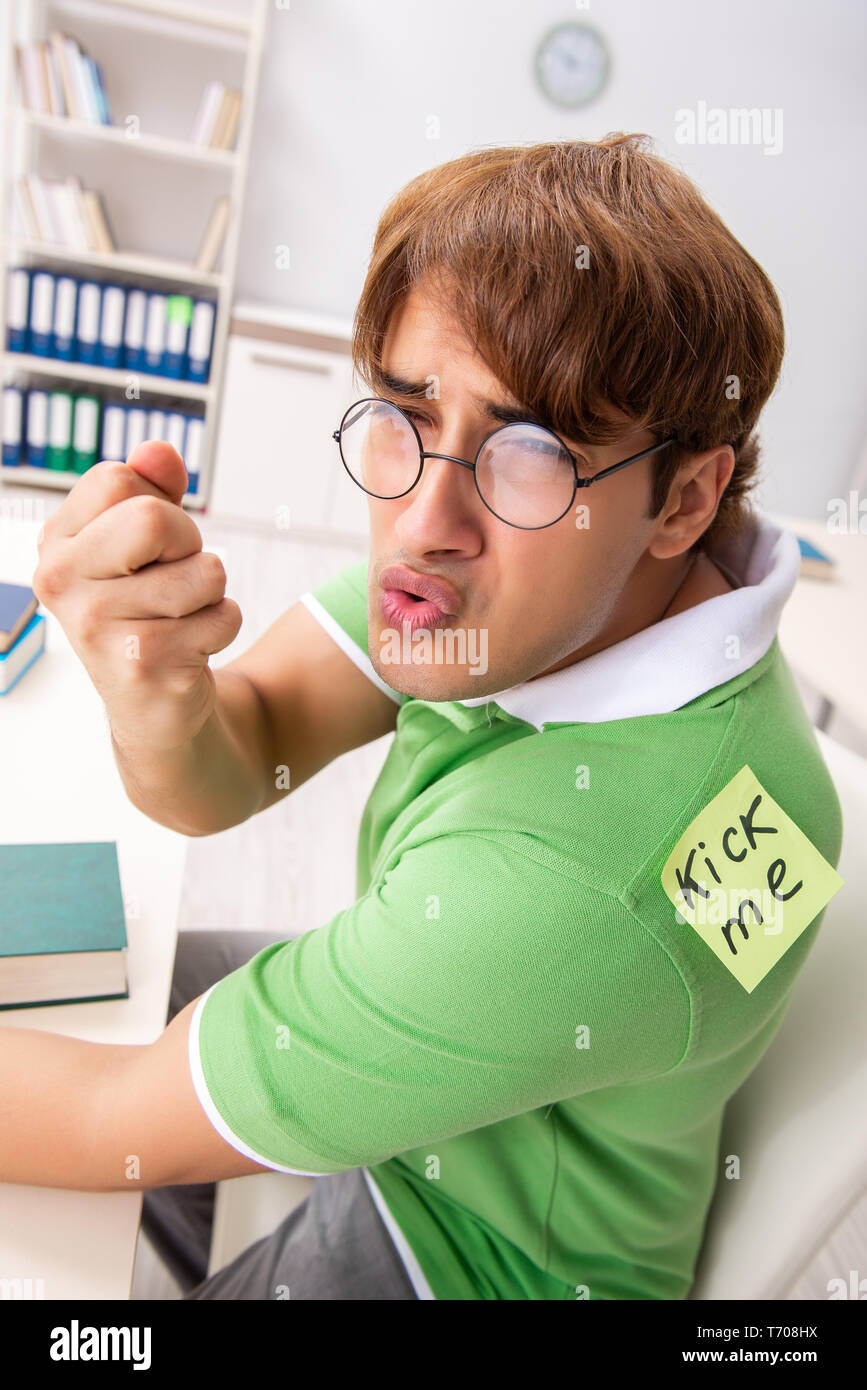 The office prank with kick me message on sticky note Stock Photo - Alamy