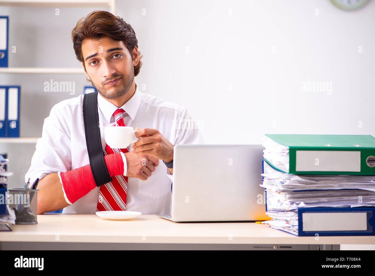 The injured employee working in the office Stock Photo - Alamy