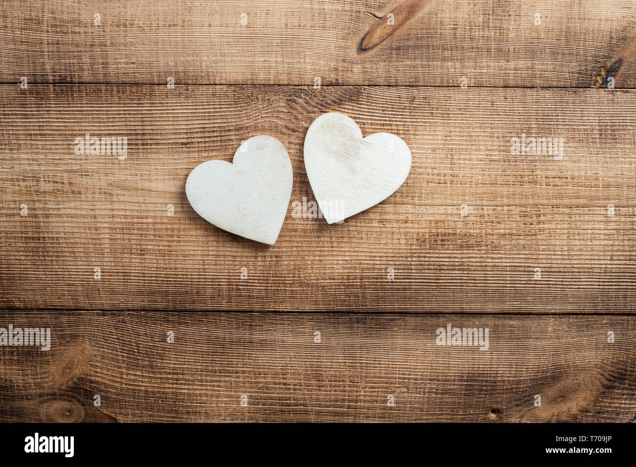 Two wood heart on a vintage wooden background Stock Photo - Alamy