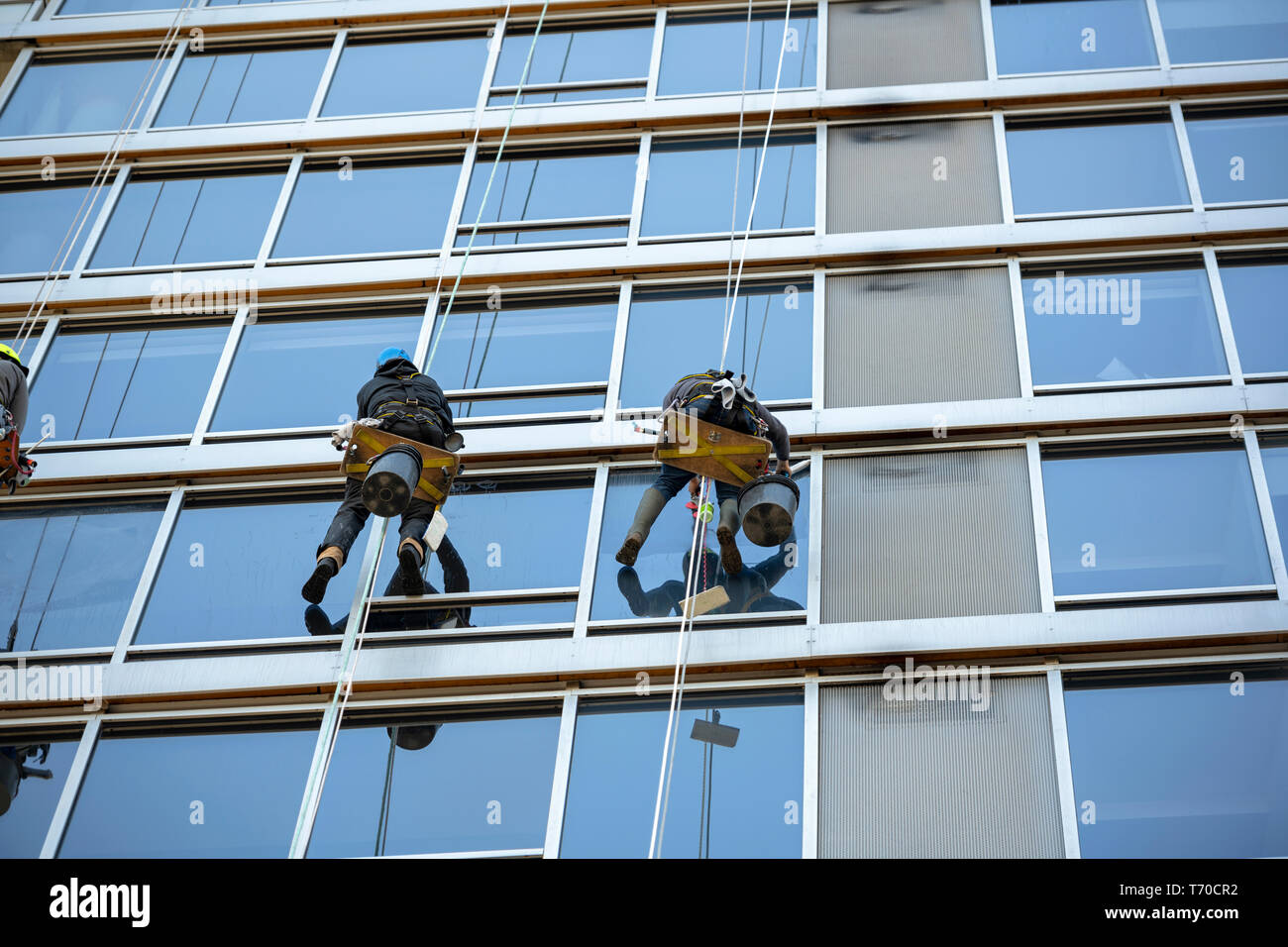 Window washers in special equipment with the necessary tools and ...