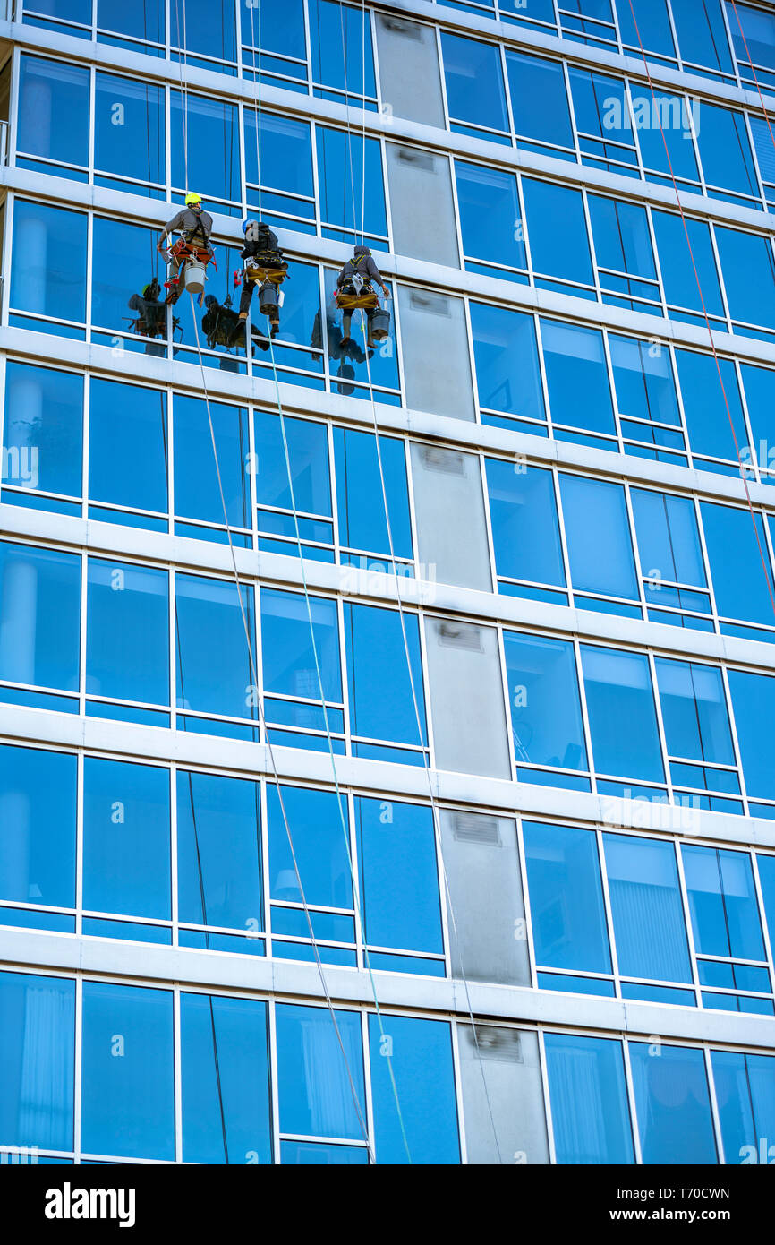 Window washers in special equipment with the necessary tools and ...